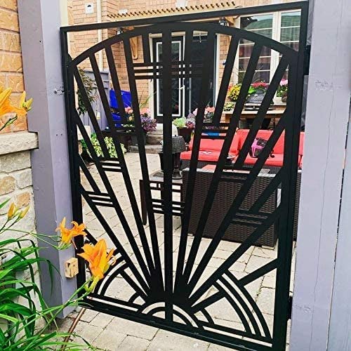 Sunspire Passage – Ornamental wrought iron man door with geometric sun